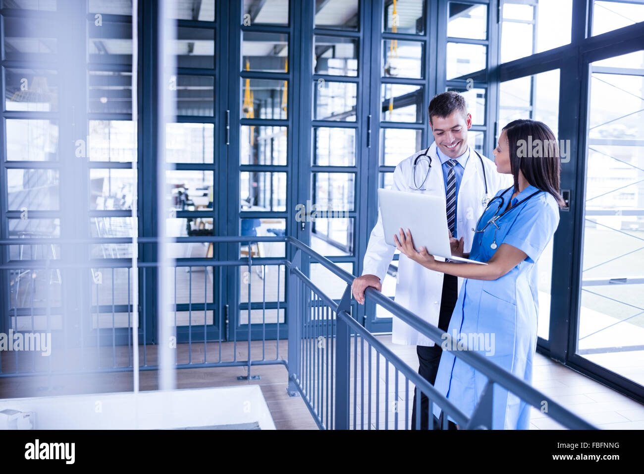 Smiling workers looking laptop hi-res stock photography and images - Alamy