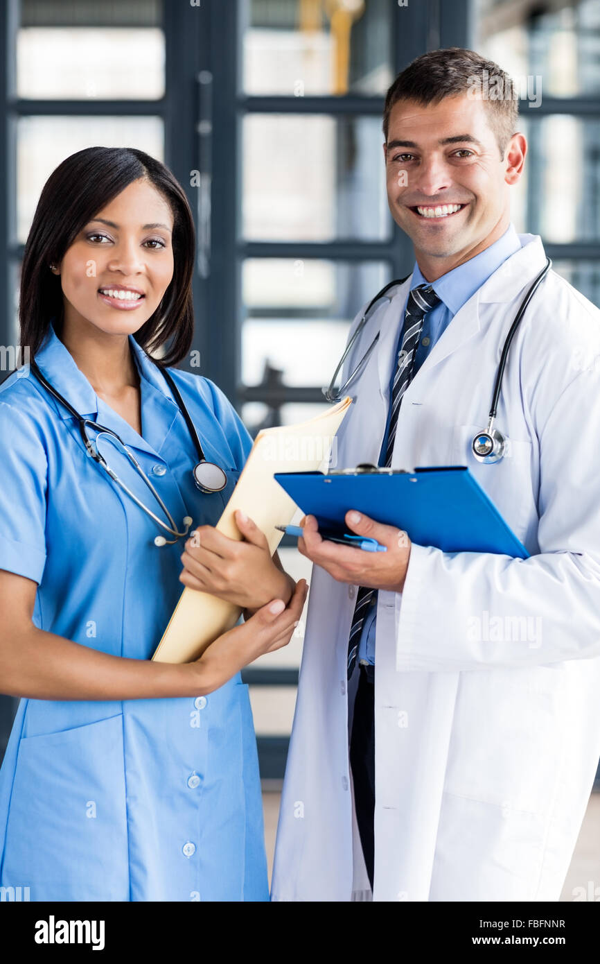 Nurse and doctor holding files Stock Photo - Alamy