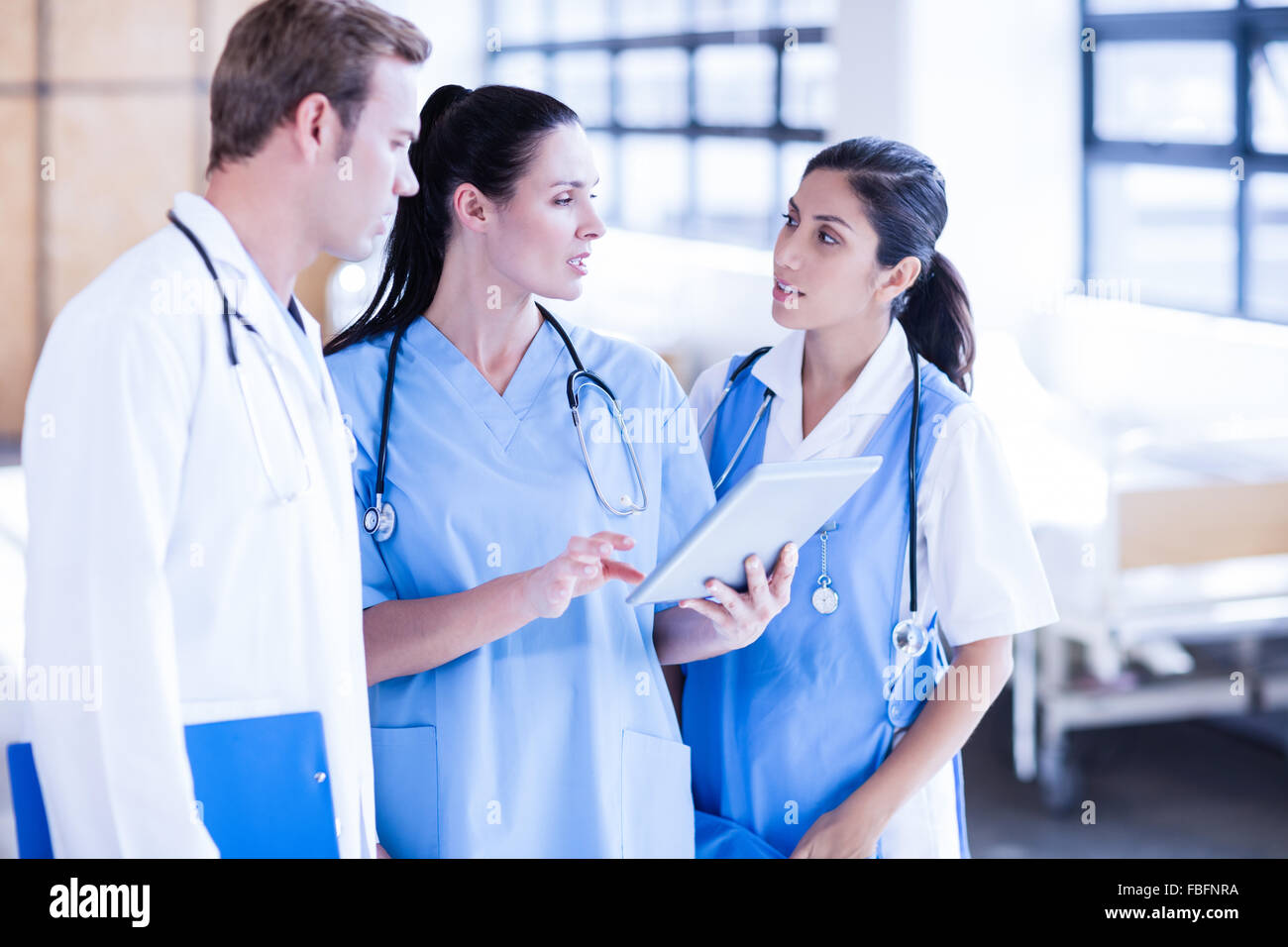 Medical team working on tablet together Stock Photo - Alamy