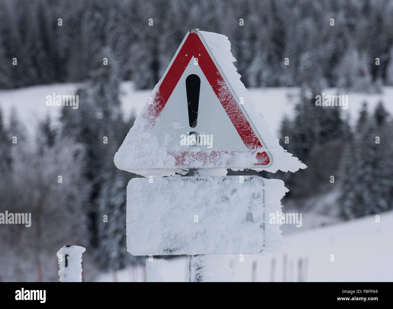 An icy warning sign on Schauinsland mountain in the Black Forest near ...