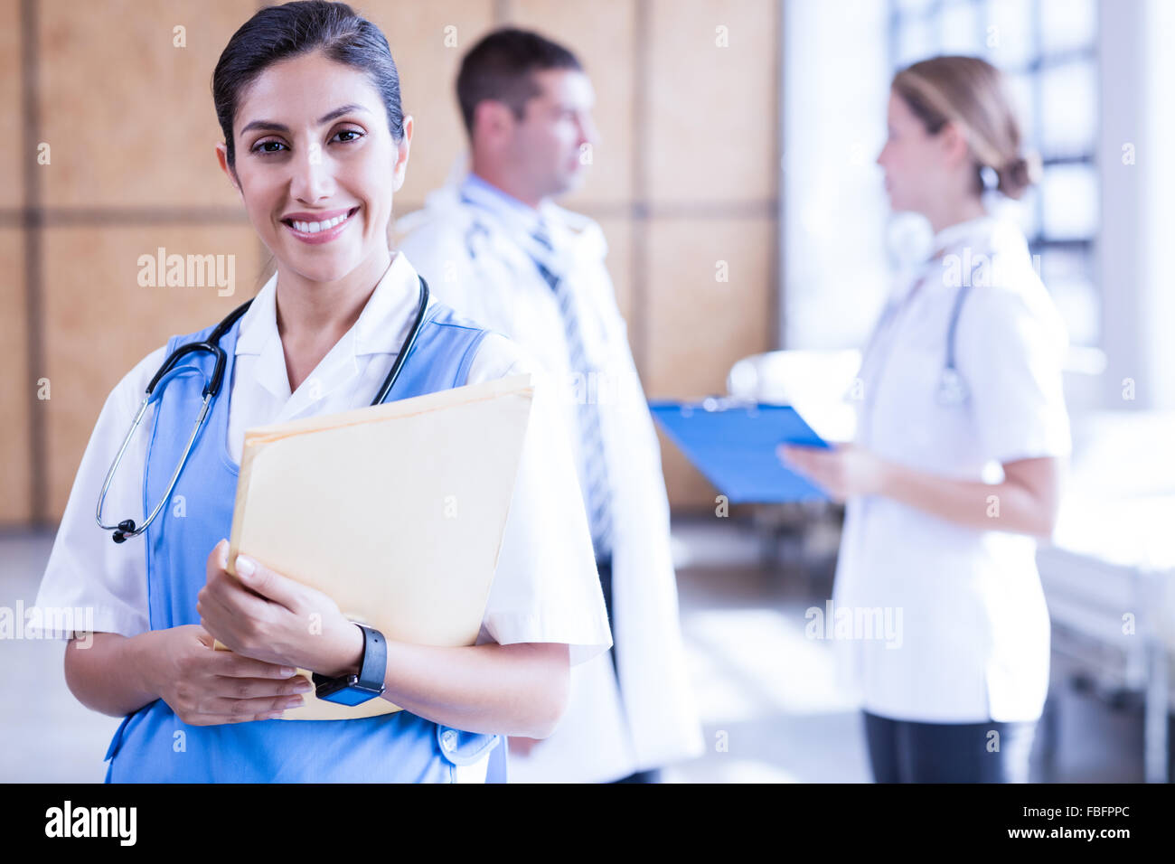 Smiling nurse holding report on clipboard Stock Photo - Alamy
