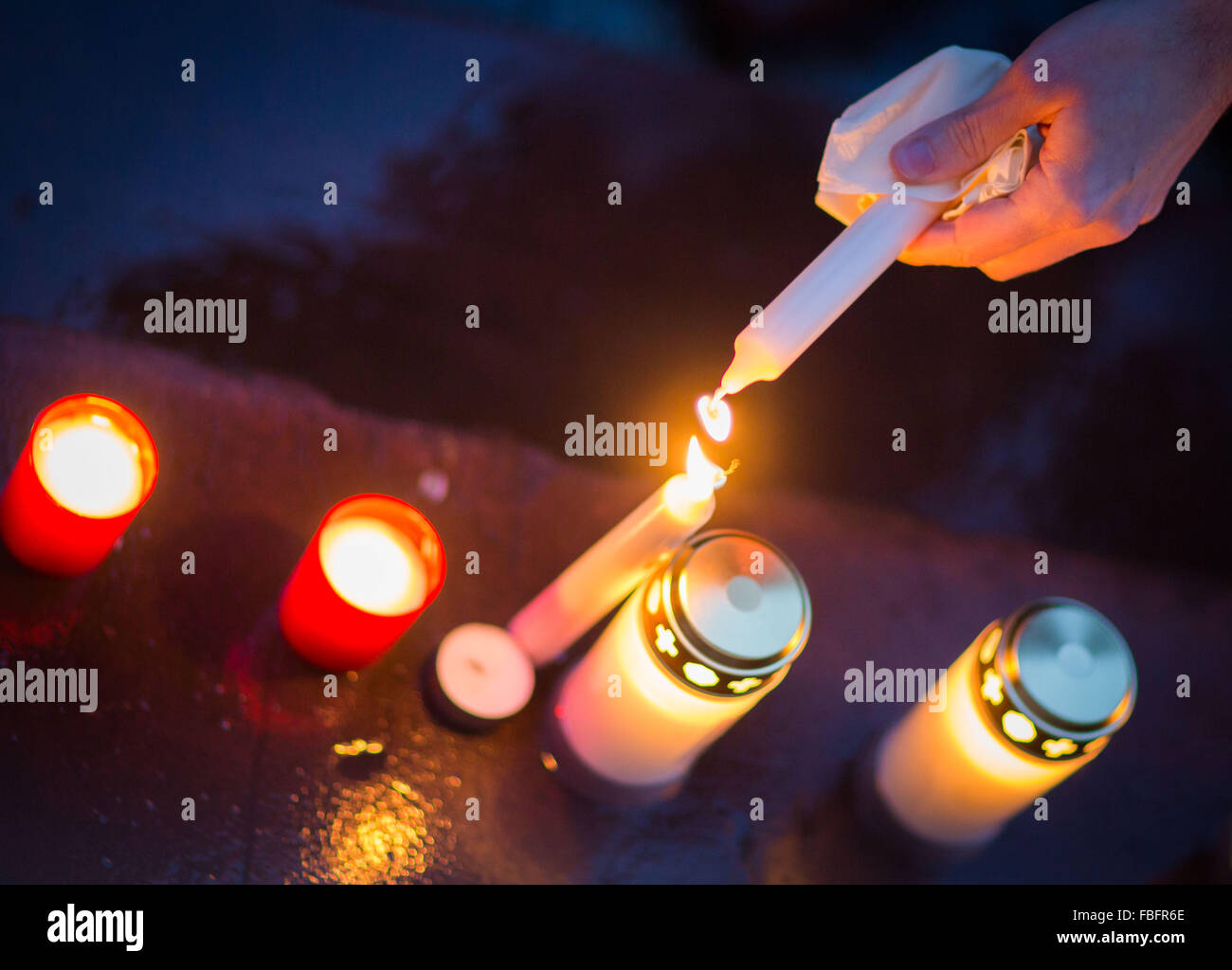 A woman holds a candle at Paulsplatz during a memorial service for the ...