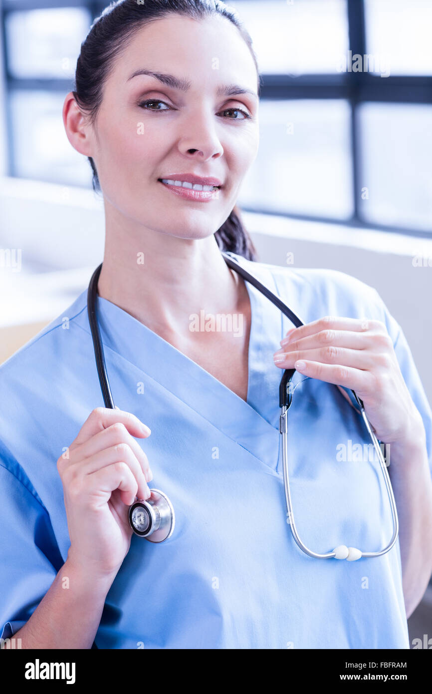 Smiling nurse posing for camera Stock Photo - Alamy