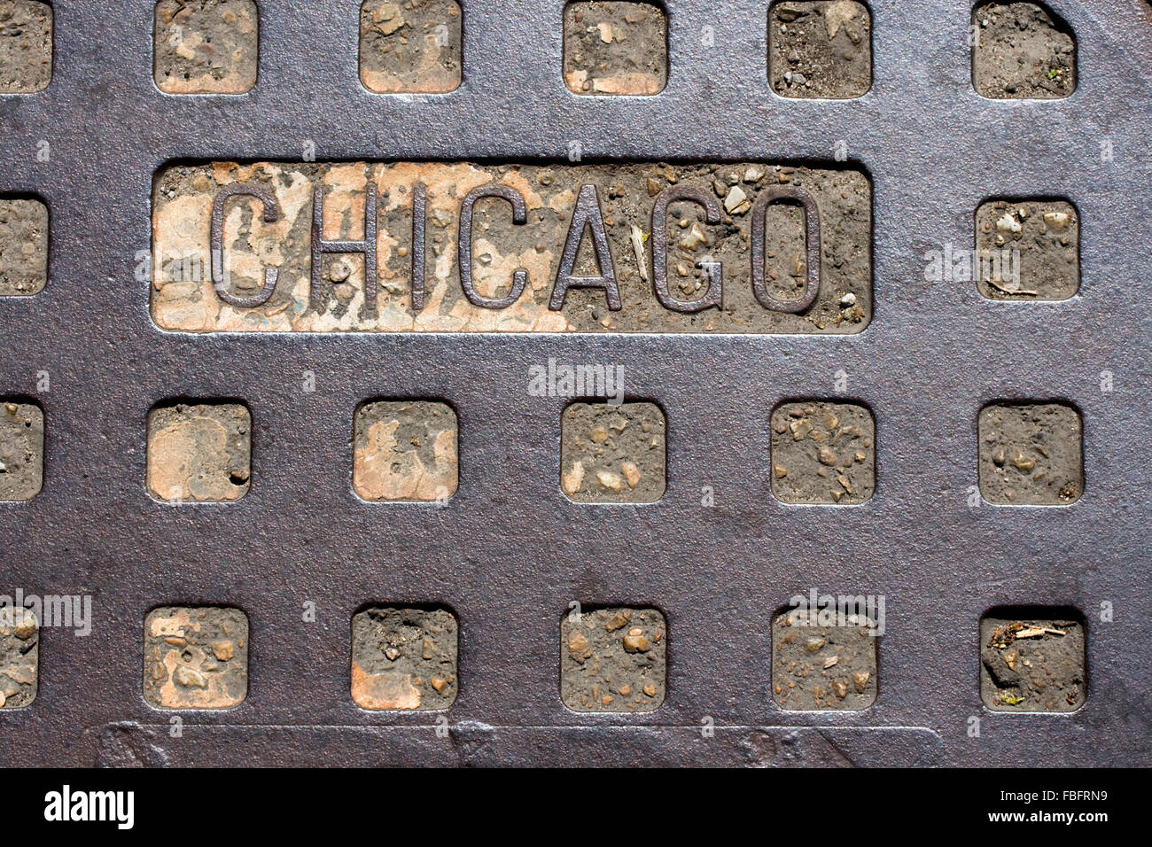 manhole cover with the word Chicago and open squares Stock Photo - Alamy