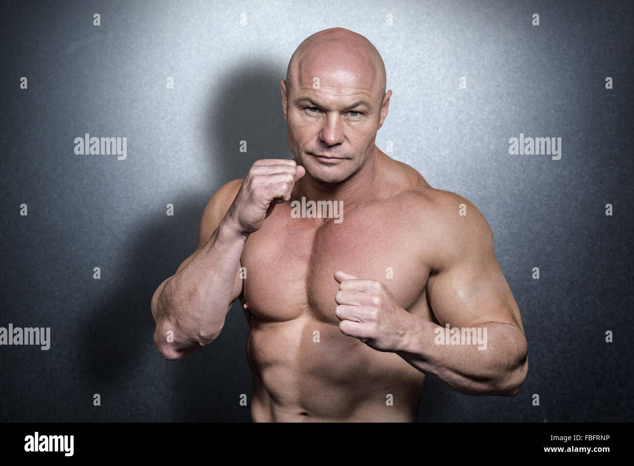 Composite image of portrait of bald man with boxing pose Stock Photo ...