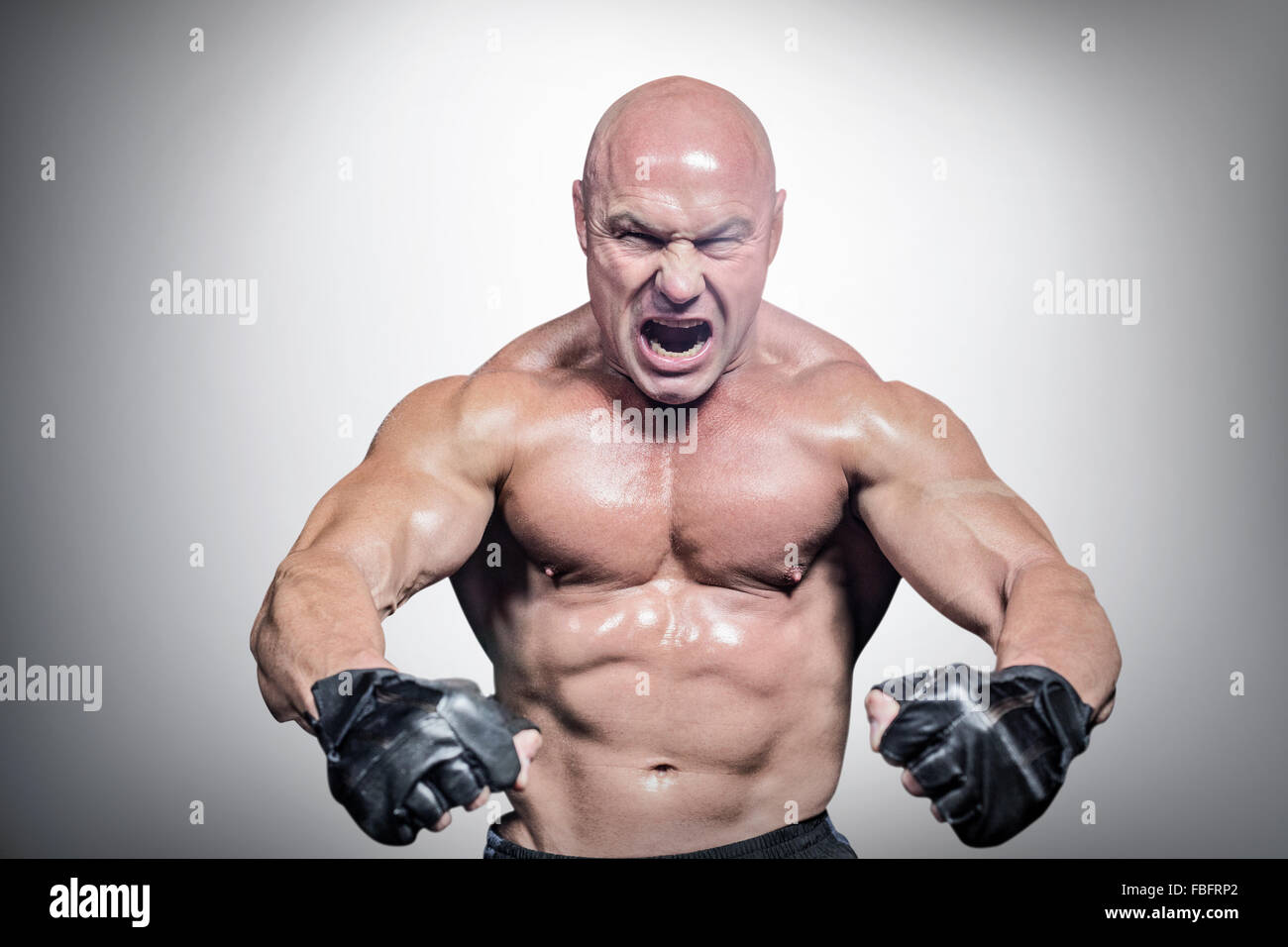 Composite image of aggressive fighter flexing muscles Stock Photo - Alamy