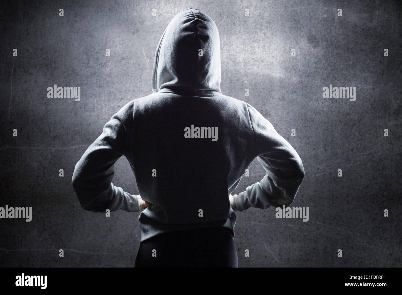 Composite image of rear view of athlete in hood Stock Photo - Alamy