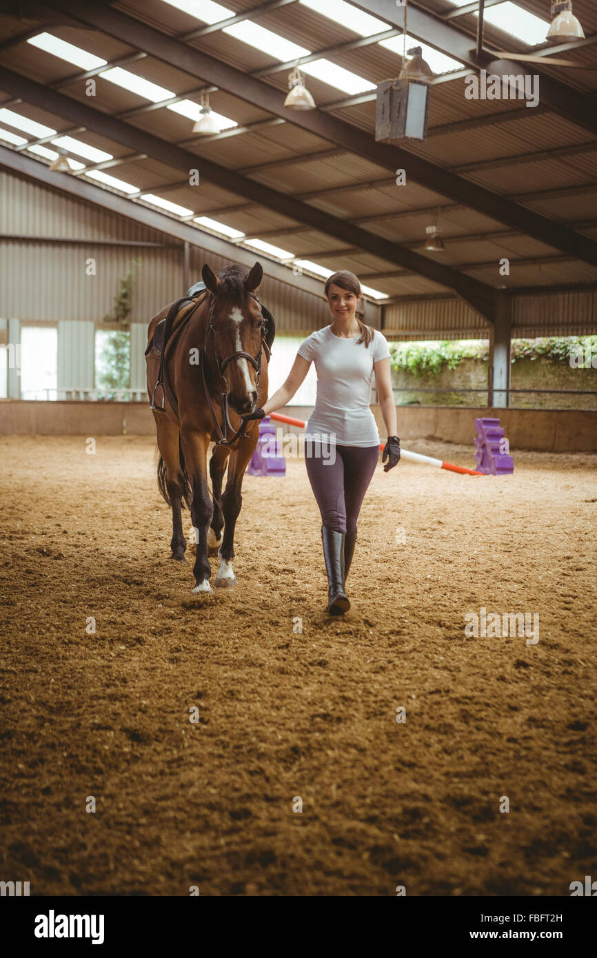 Female rider leading her horse Stock Photo - Alamy