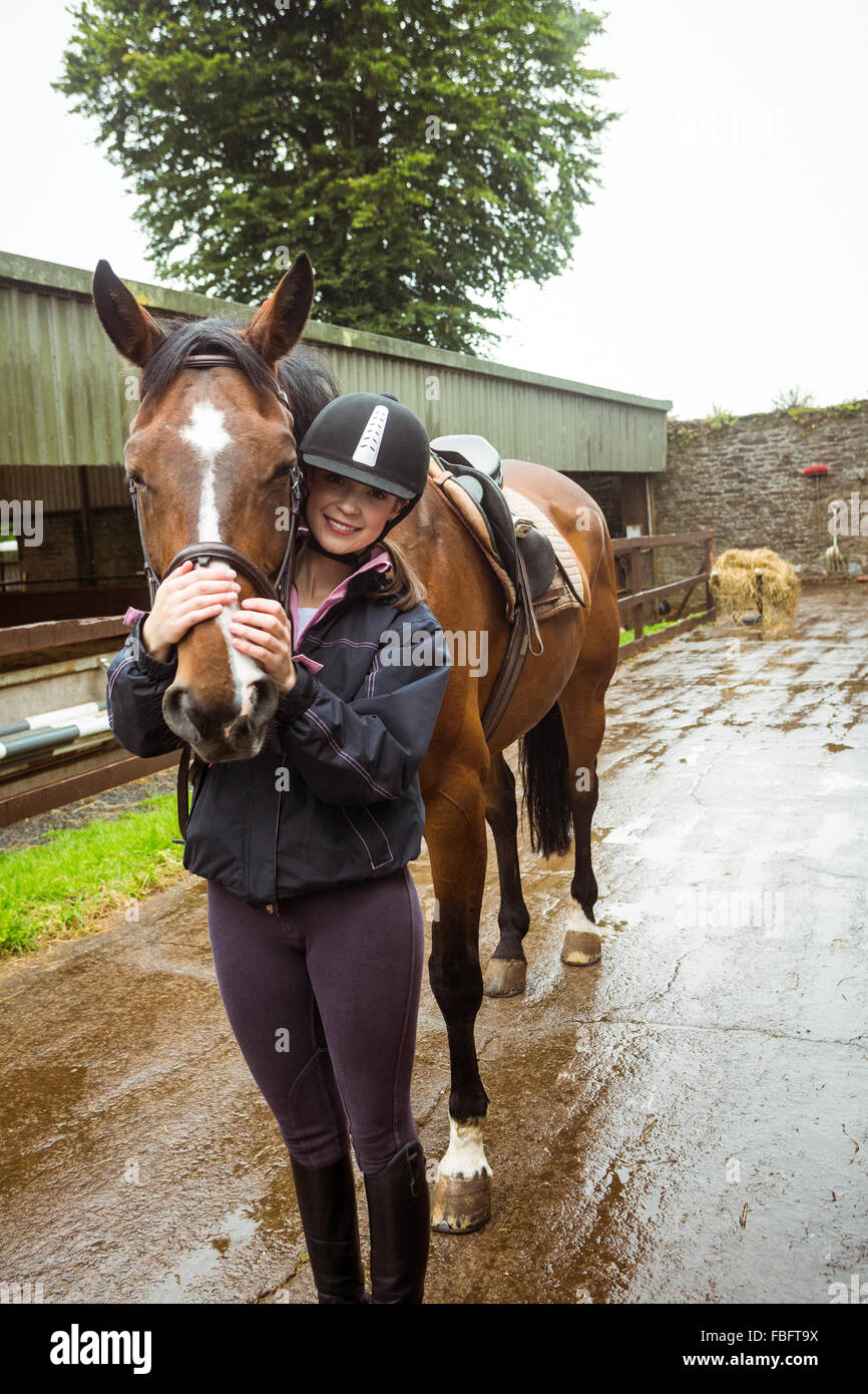 Pretty woman hugging her horse Stock Photo - Alamy
