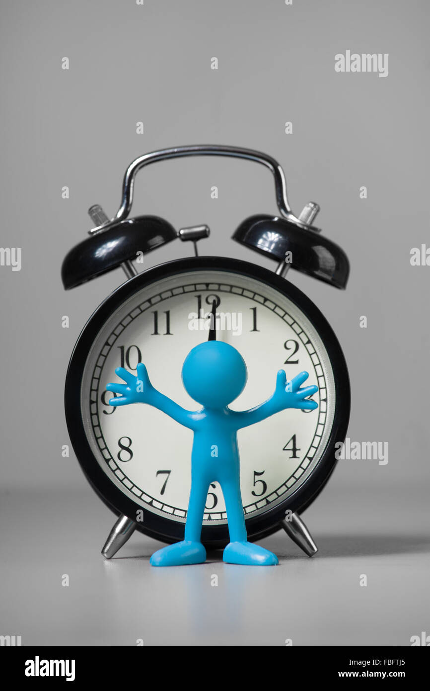 Blue man and an alarm clock Stock Photo - Alamy