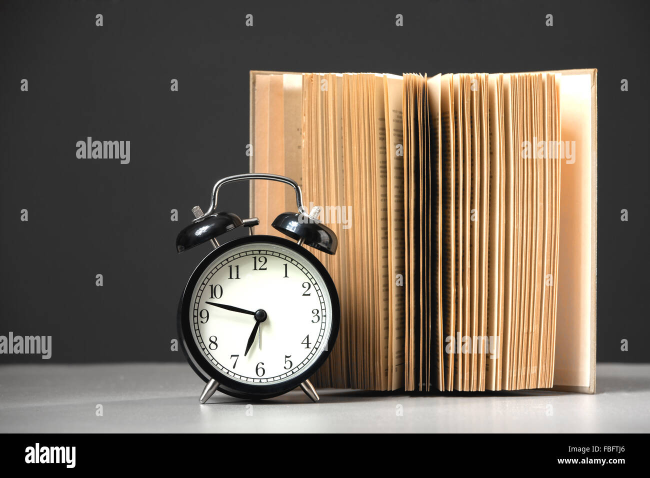 Alarm Clock And Book Stock Photo - Alamy
