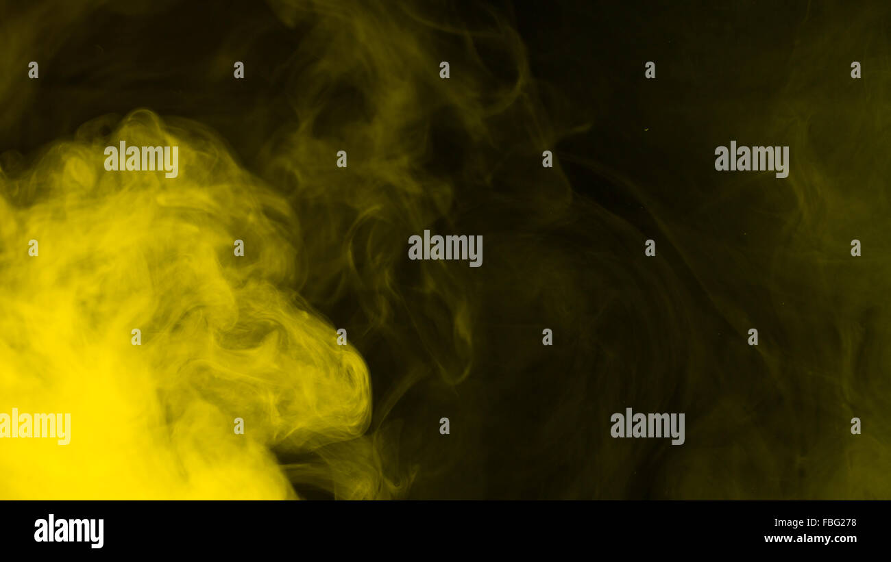 Abstract art. Yellow smoke hookah on a black background. Inhalation ...