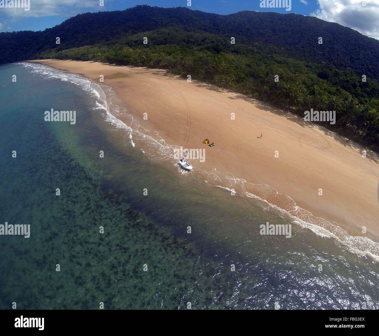 People and boat on beach at remote Shipwreck Bay, Daintree National ...