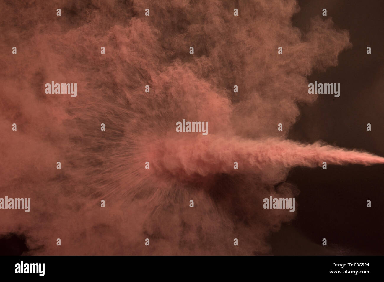 Vibrant Color splash seen beeing thrown in the air. During night time ...