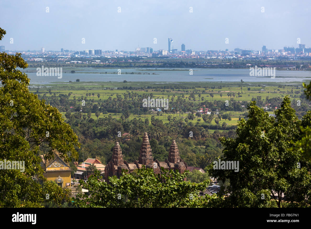 Towers of Prasat Phnom Reap temple, rear skyline of Phnom Penh ...