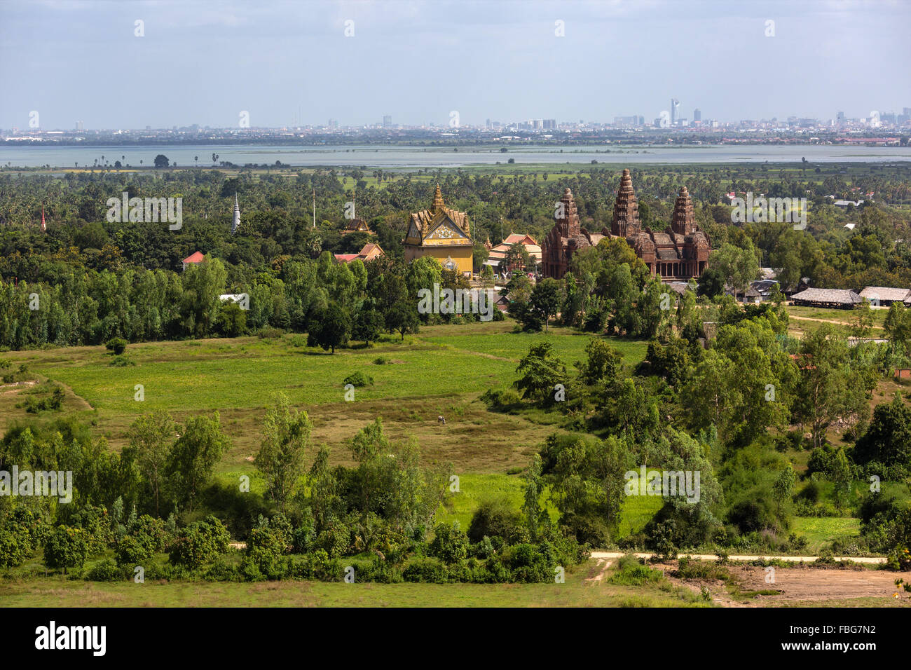 Towers of Prasat Phnom Reap temple, rear skyline of Phnom Penh ...