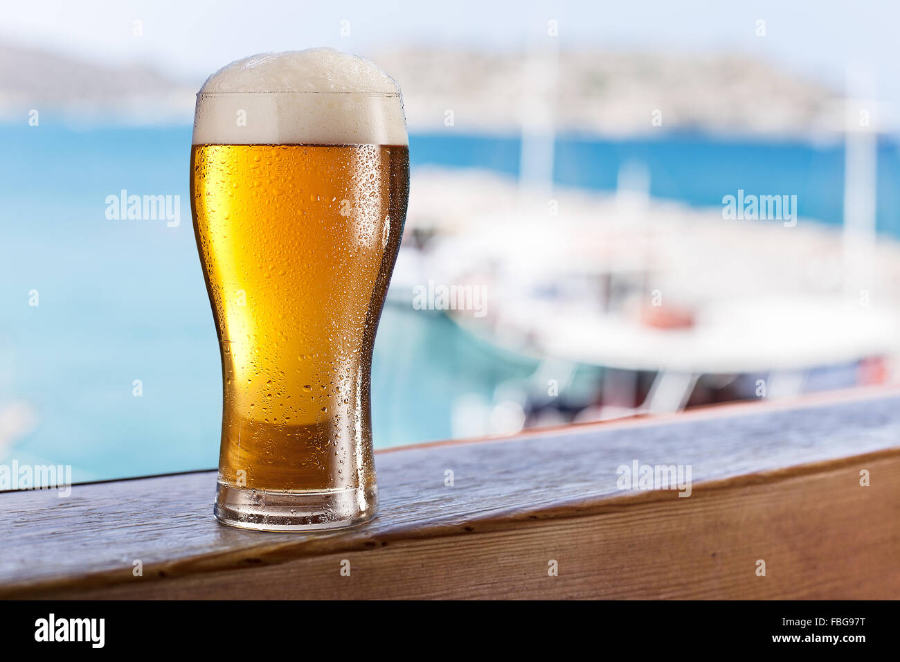 Glass of light beer on the seaside bar counter Stock Photo - Alamy