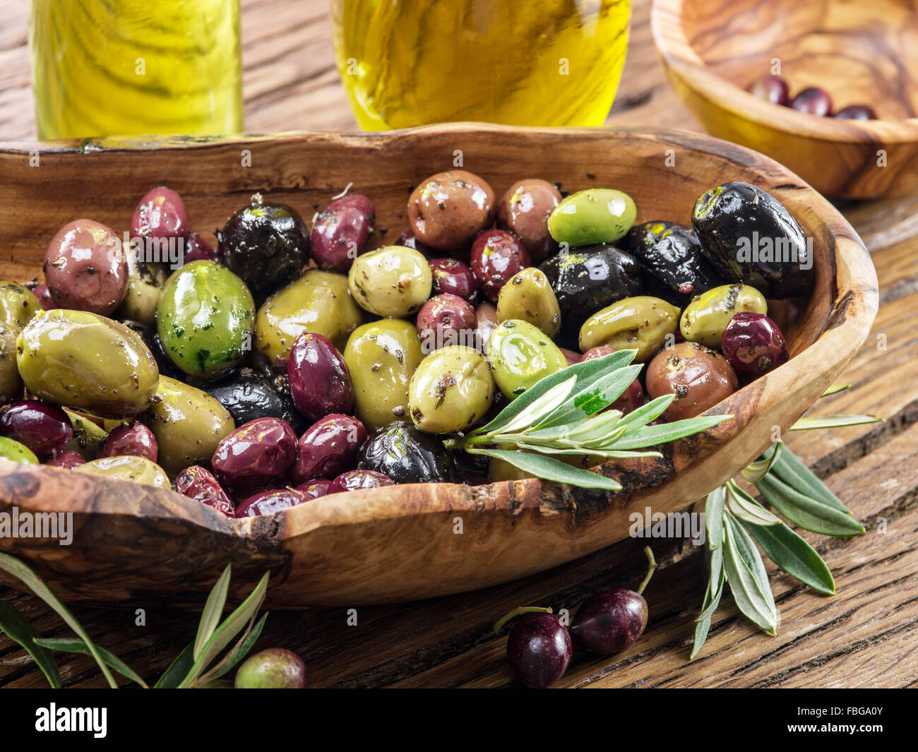Whole table olives in the wooden bowl on the table Stock Photo - Alamy