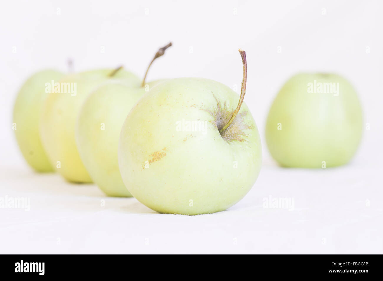 Light green apples on a white background Stock Photo - Alamy