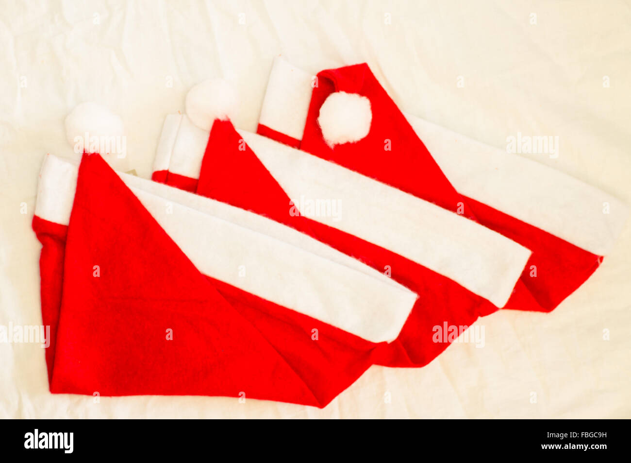 Santa hats on a white background top view Stock Photo - Alamy