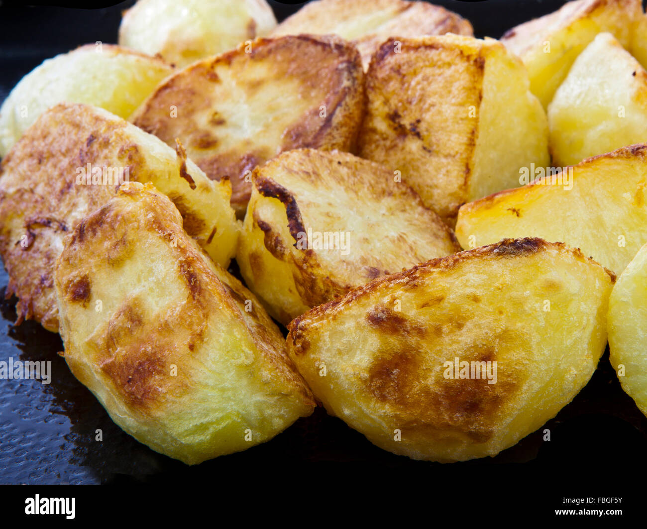 Fresh Roast Potato's on a baking tray Stock Photo - Alamy