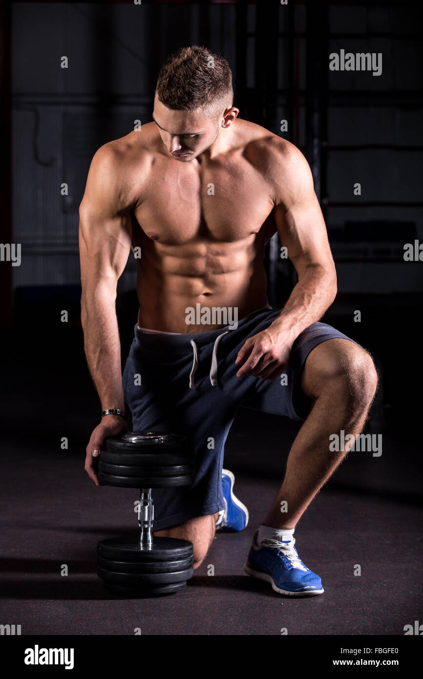Portrait of young attractive caucasian muscular man working out in gym ...