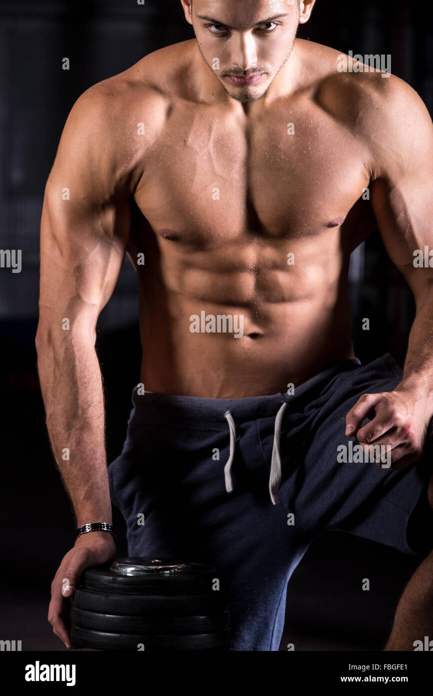 Portrait of young attractive caucasian muscular man working out in gym ...