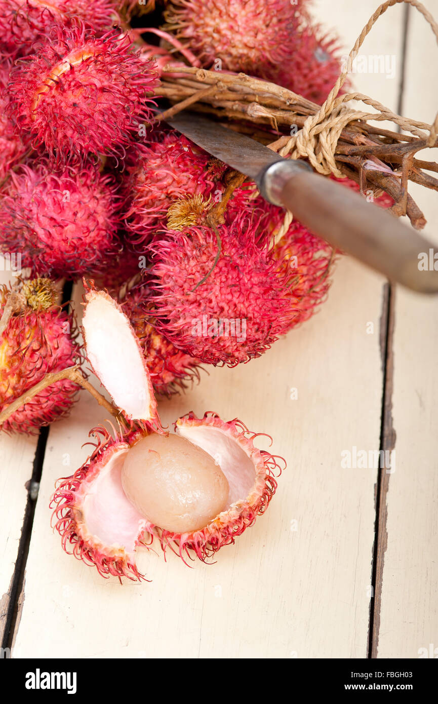 fresh tropical rambutan fruits over rustic wood table Stock Photo - Alamy