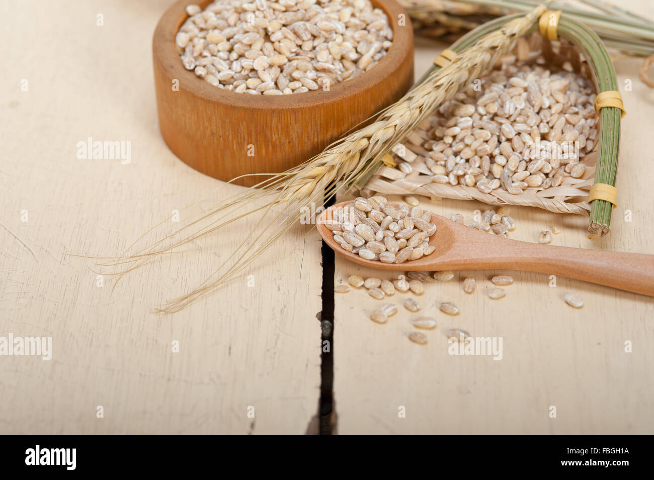 organic wheat grains over rustic wood table macro closeup Stock Photo ...