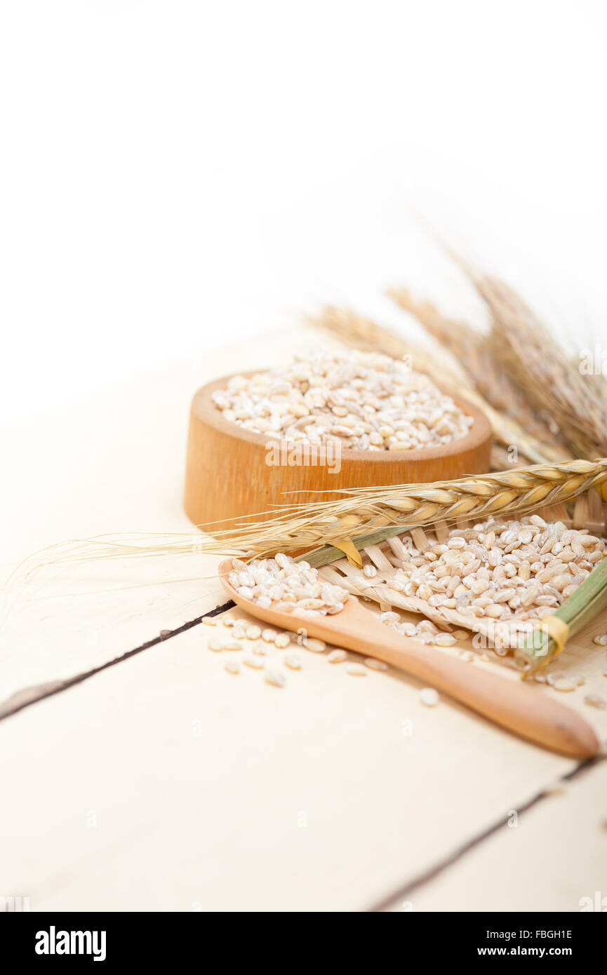 organic wheat grains over rustic wood table macro closeup Stock Photo ...
