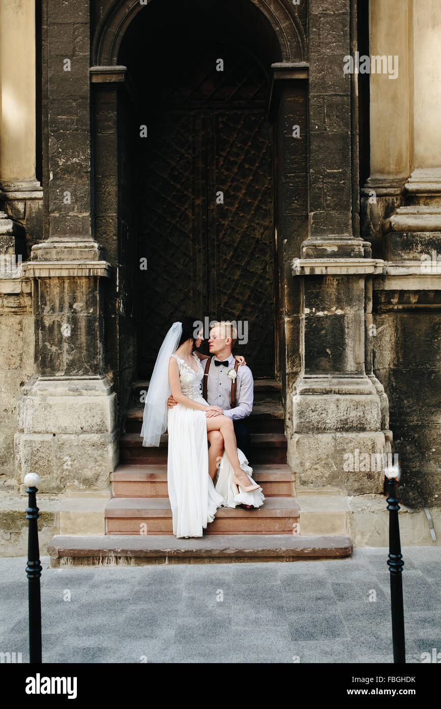 Bride sitting on lap of the bride Stock Photo - Alamy