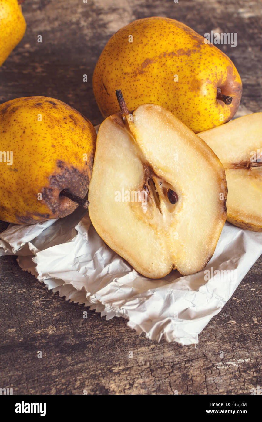 Sweet pears on a rustic wooden desk. Selective focus Stock Photo - Alamy