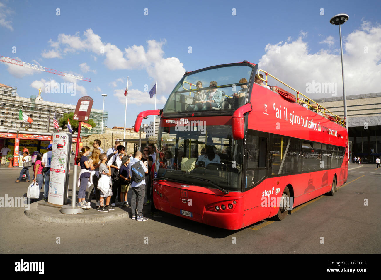 Tourists getting onto bus for guided tour at Roma Termini railway ...