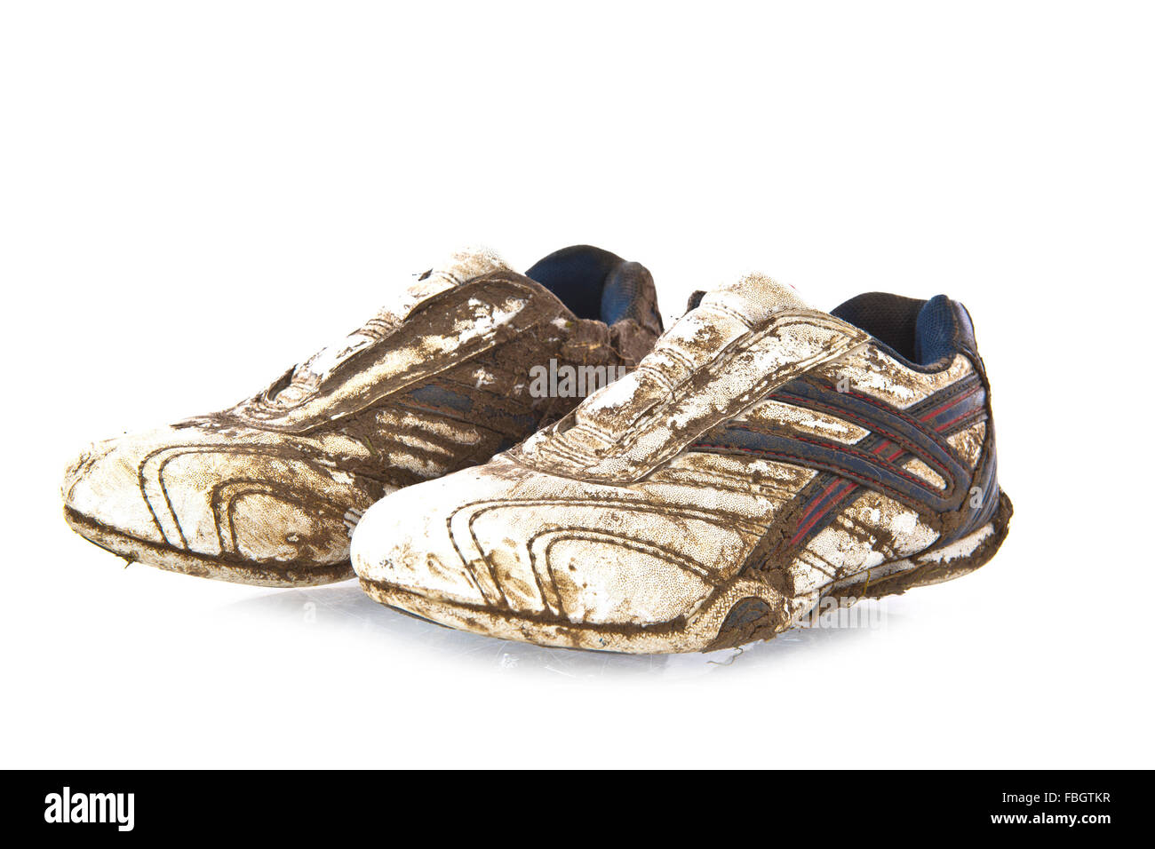 Muddy Trainers on white background Stock Photo - Alamy