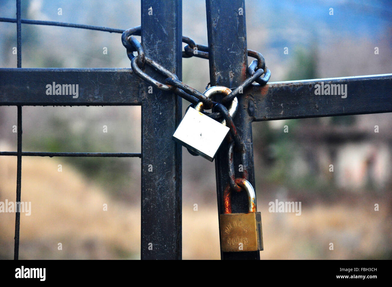 black iron gate with brass padlocks Stock Photo - Alamy