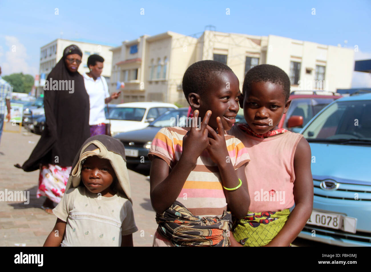 A group of children stand on a sidewalk in Bujumbura, Burundi, 10 ...