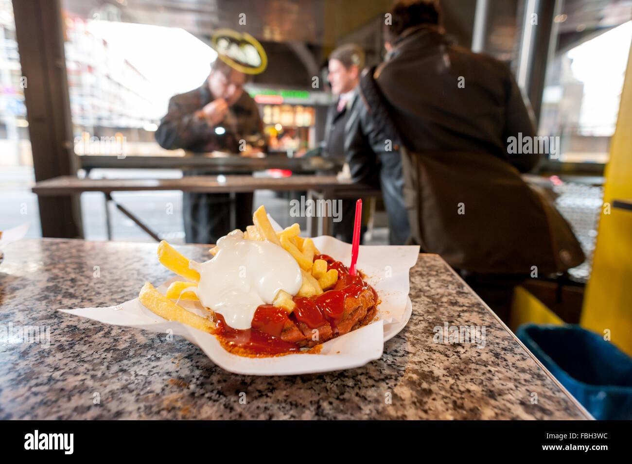 A currywurst with chips in a Berlin imbiss Stock Photo - Alamy