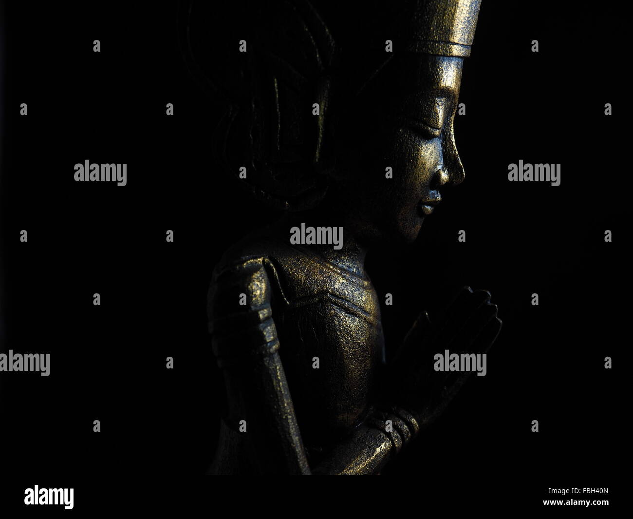 Golden Buddha profile low key Stock Photo - Alamy