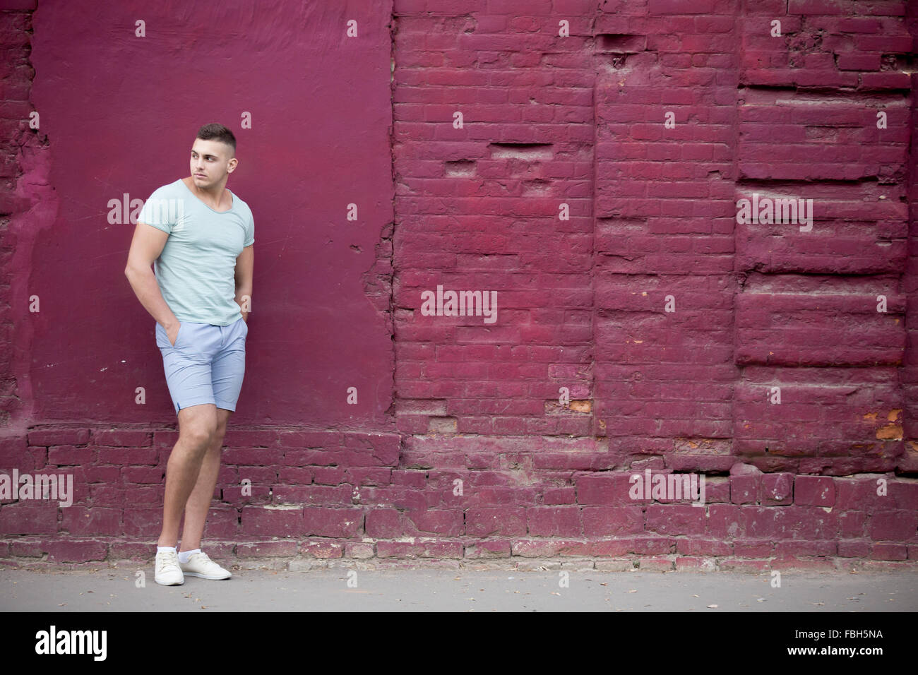 Portrait of confident serious hot guy wearing casual clothing walking ...