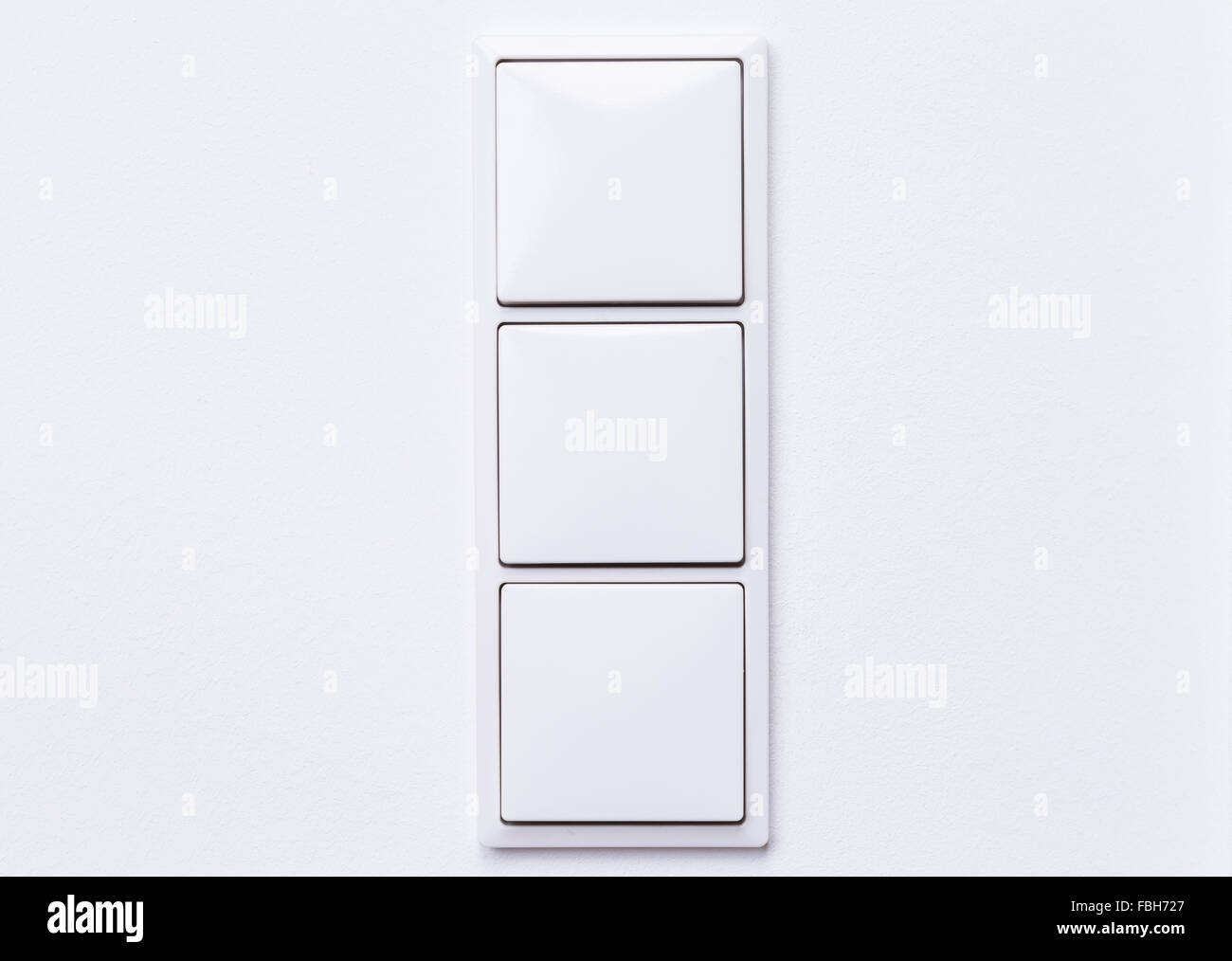 Image shows a triple circuit breaker on a white wall Stock Photo - Alamy