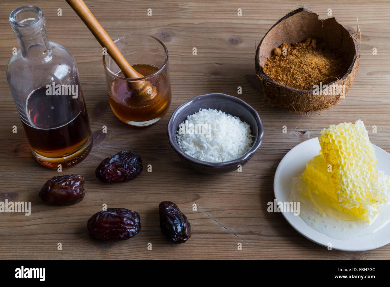 Selection of sweetener ingredients including honey sugar and maple ...
