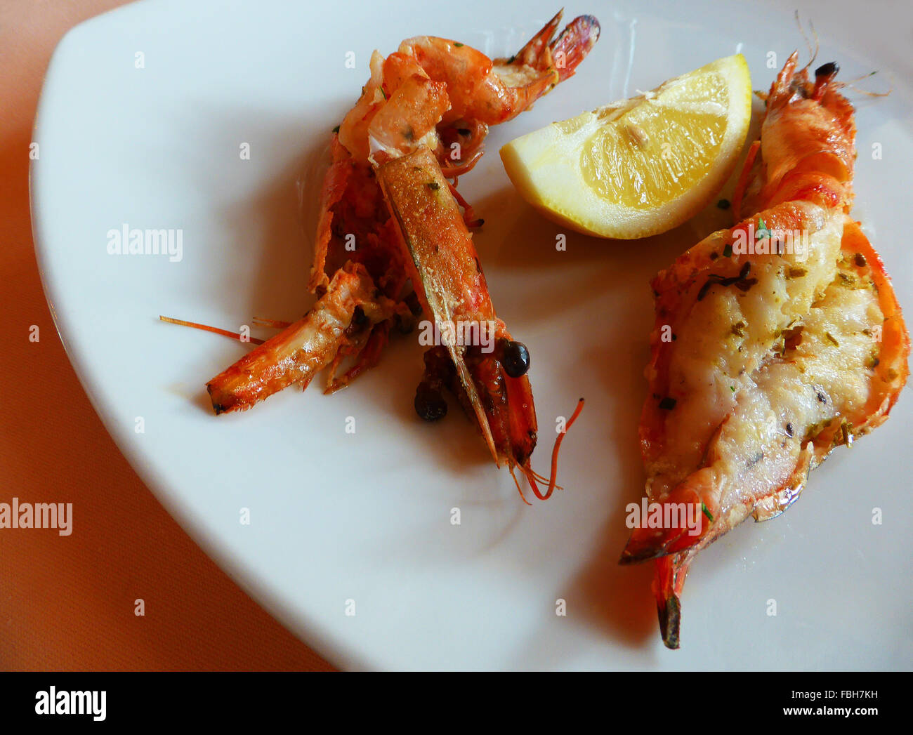 Scampi dish with lemon Stock Photo - Alamy