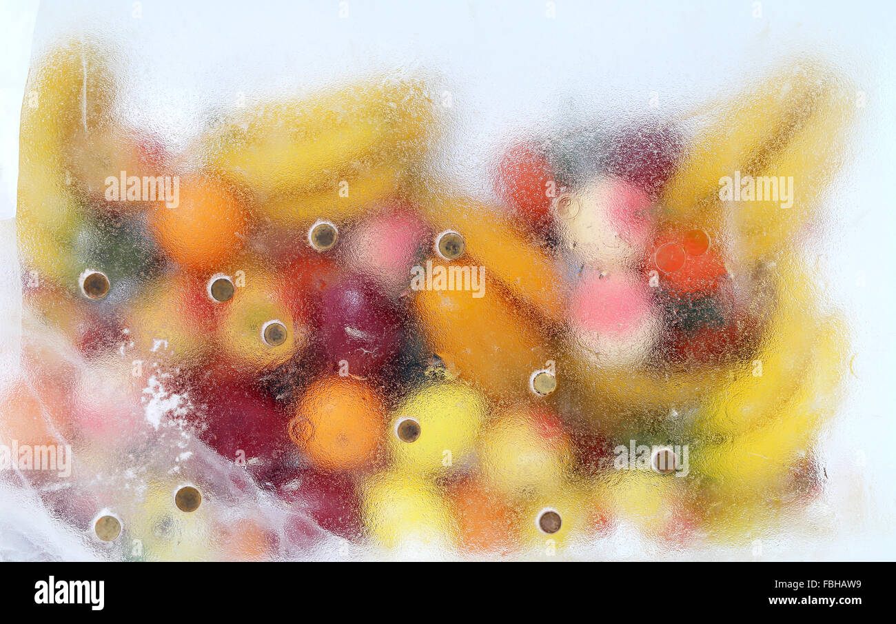 Delicious fruit frozen in a block of ice Stock Photo - Alamy