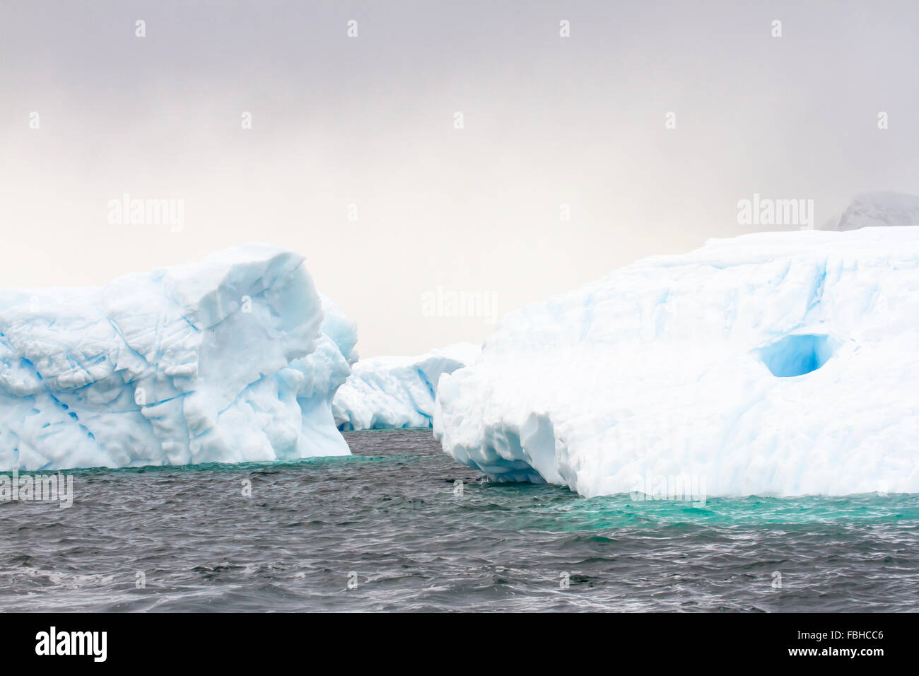 Floating icebergs of blue glacial ice in Antarctica Peninsula Stock ...