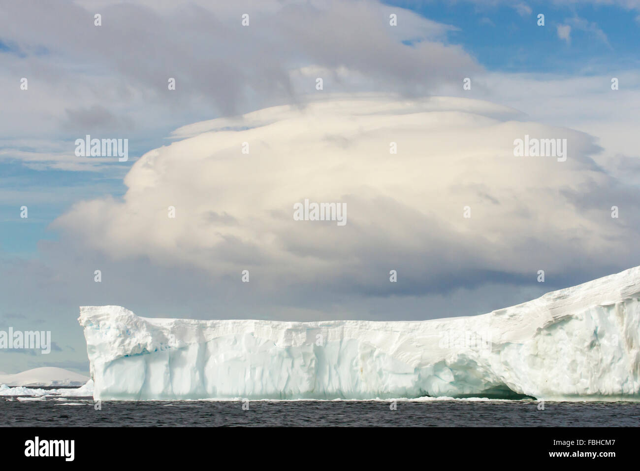 Lintiular cloud over tabular iceberg in antarctica Stock Photo - Alamy