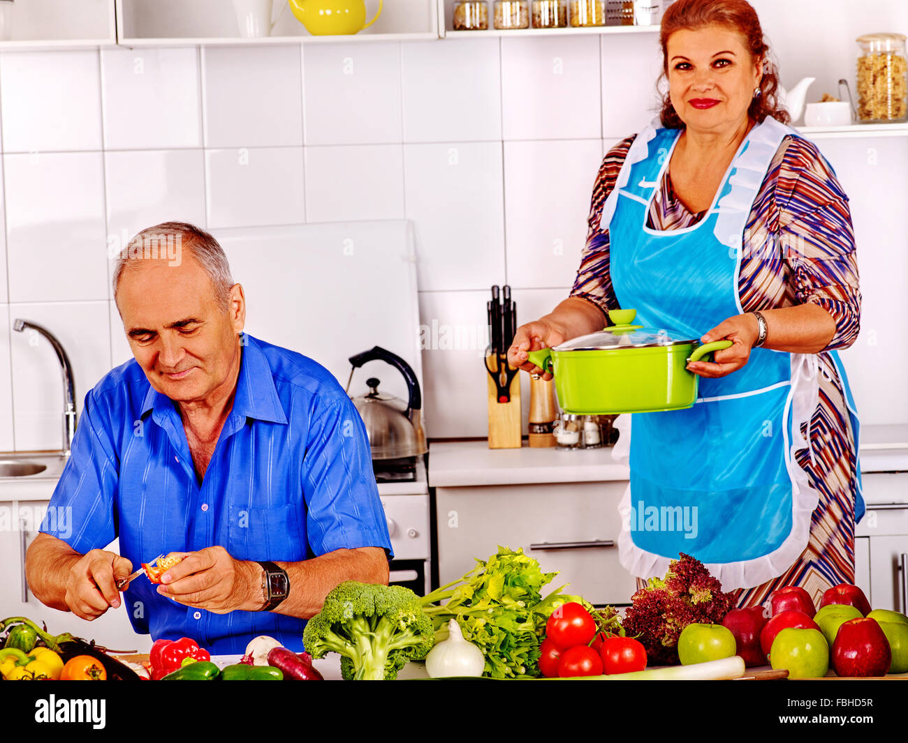 Senior couple cooking at kitchen Stock Photo - Alamy