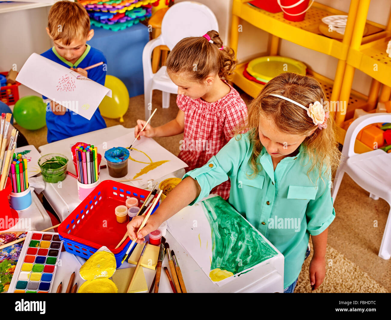 Two girls painting in kindergarten Stock Photo - Alamy