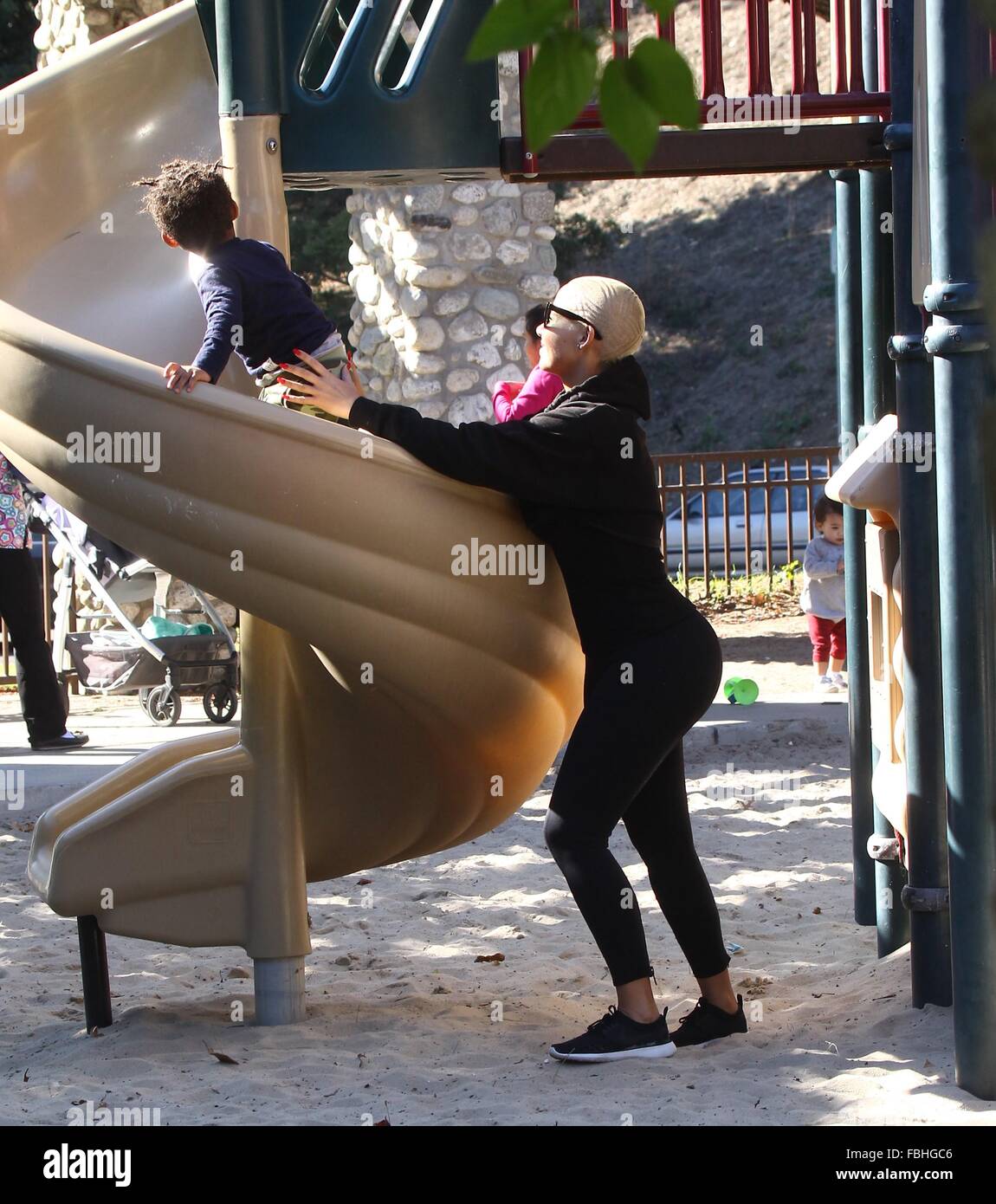 Amber Rose dressed in a FVCKA jogging suit, takes her son to the park ...
