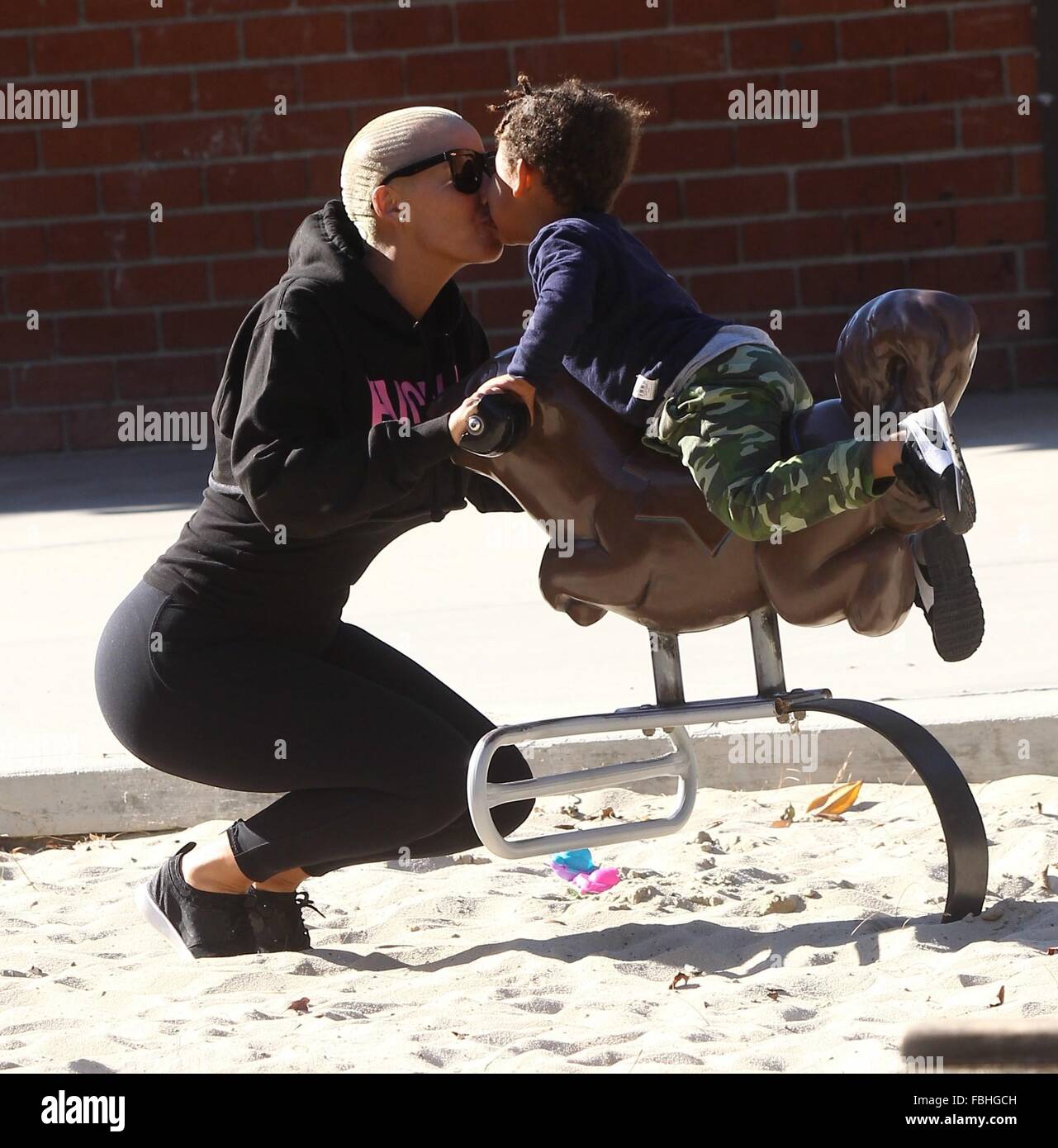 Amber Rose dressed in a FVCKA jogging suit, takes her son to the park ...