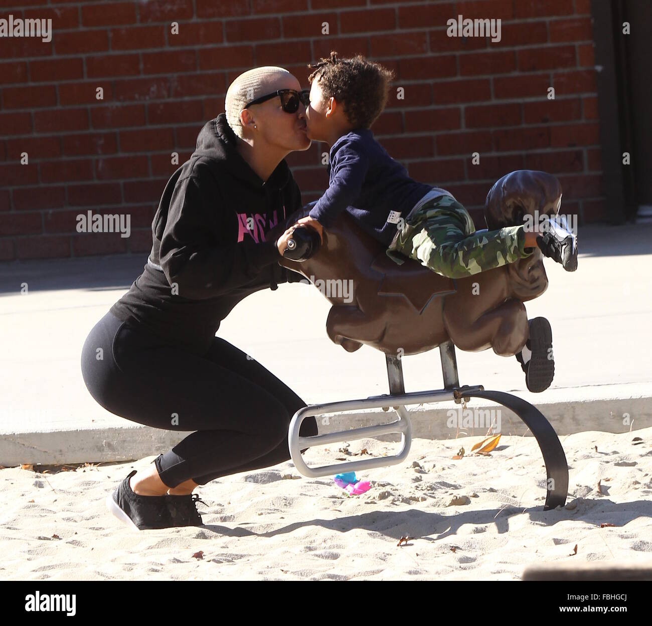 Amber Rose dressed in a FVCKA jogging suit, takes her son to the park ...